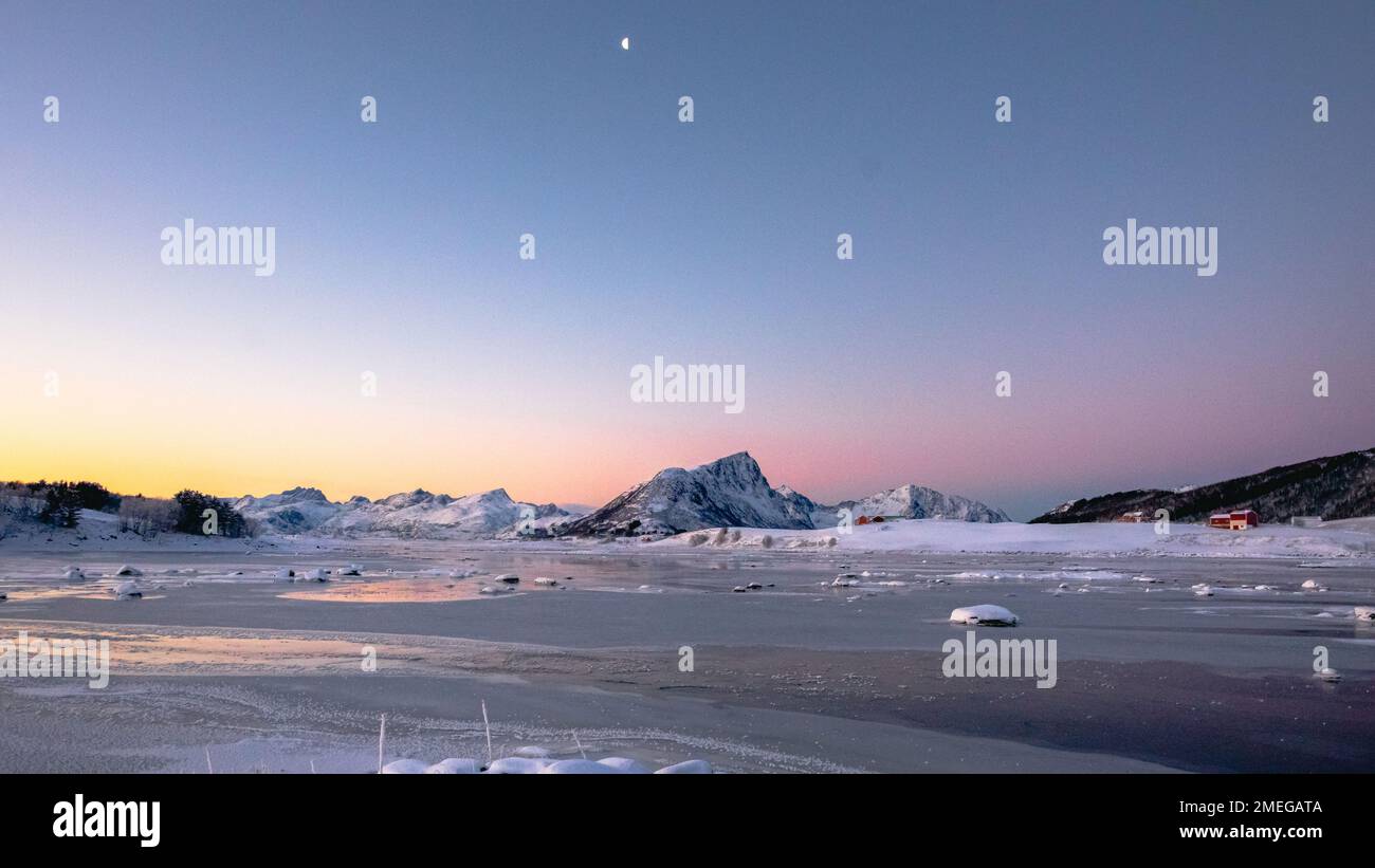 Snowy winter pastel color landscape of a frozen fjord in arctic Lofoten ...