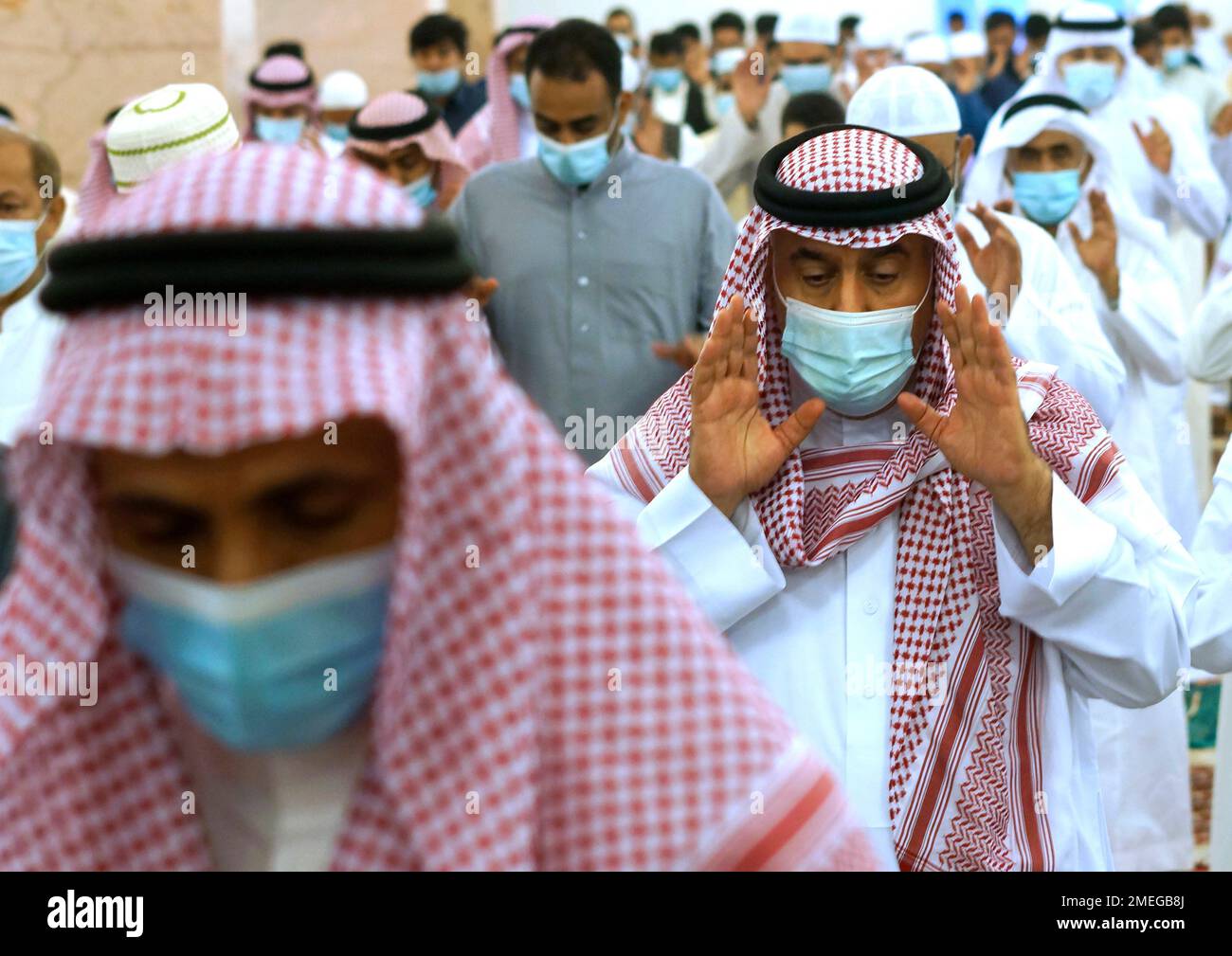 Saudis wear masks and keep social distancing, to curb the spread of ...