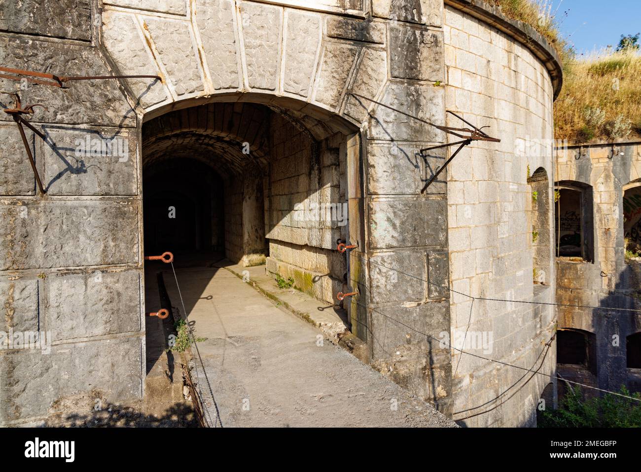 Concrete old walls of a dark empty narrow corridor of the ancient ...