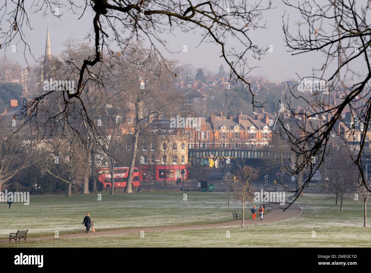 Park users walk through Brockwell Park on a cold January winter morning ...
