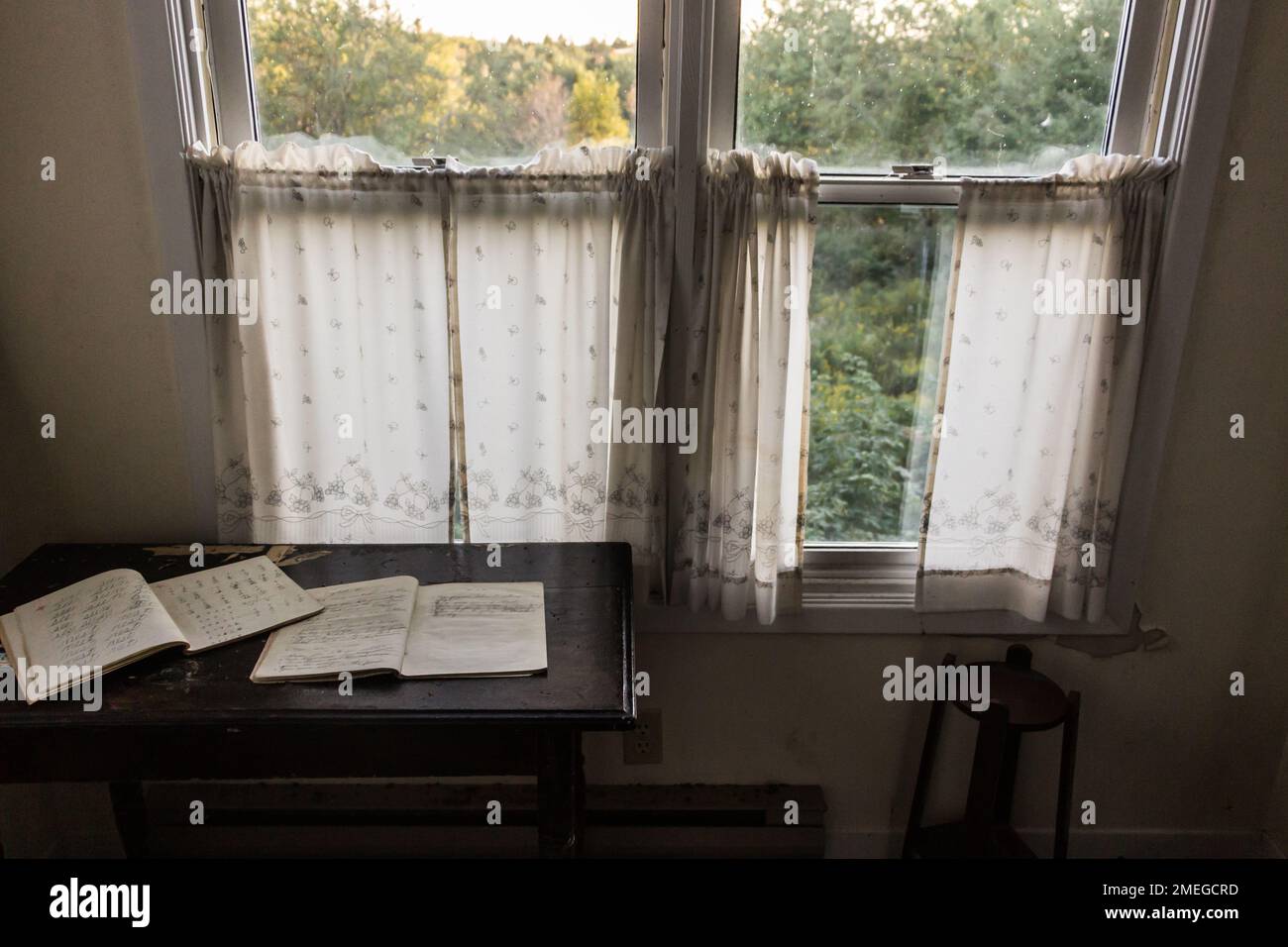 A view of old windows and table with books on it Stock Photo - Alamy