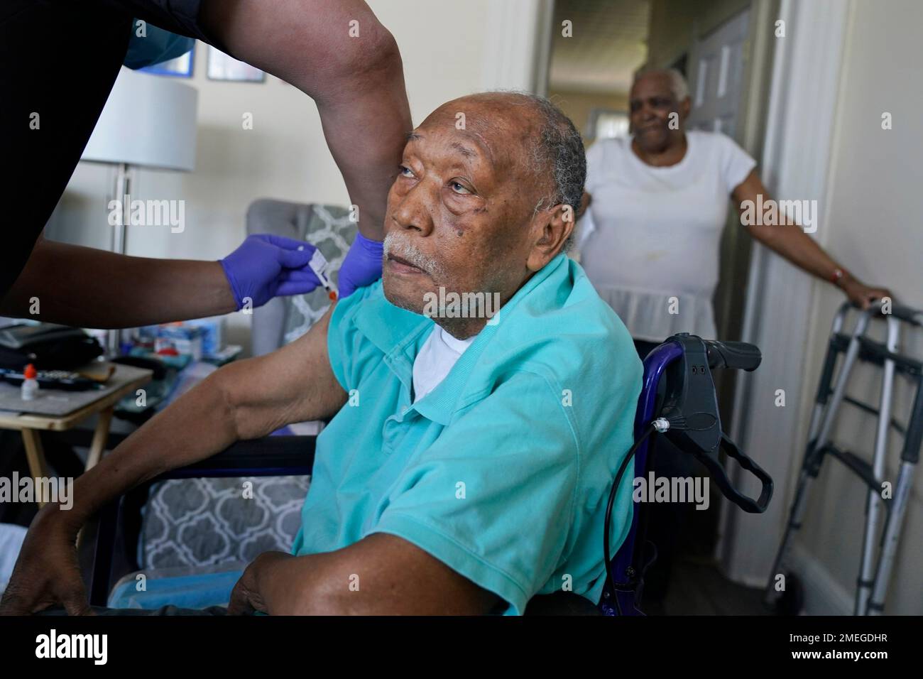 Paramedic Bob Bertollo administers the COVID-19 vaccine to Harold Ward ...
