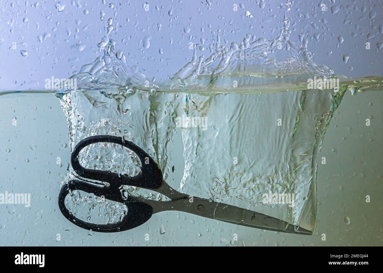 scissors fall into the water. sprays, drops and bubbles Stock Photo - Alamy