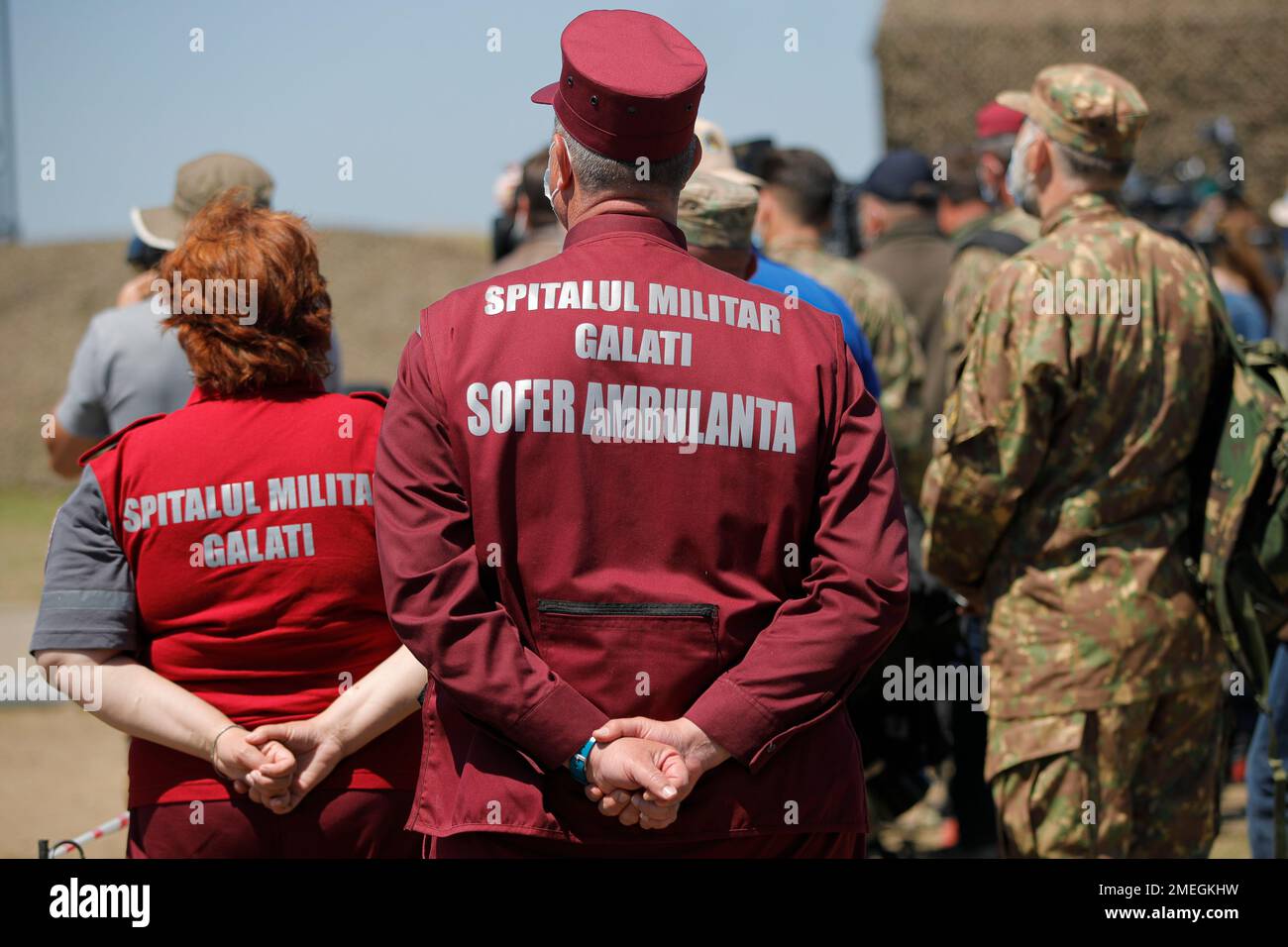 Romanian paramedics watch troops from Poland and Romania after the ...