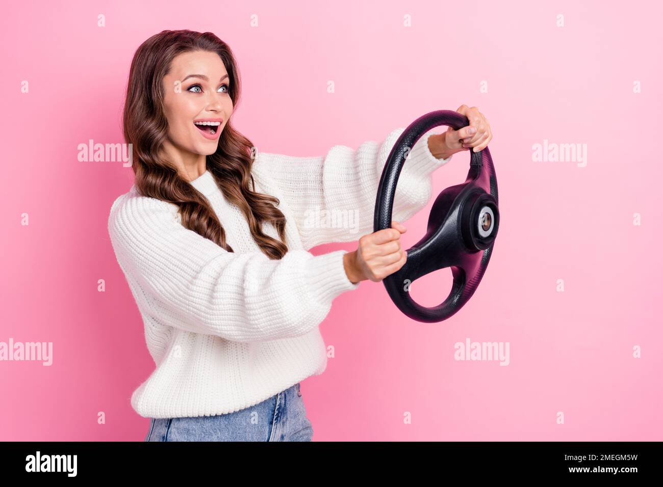 Profile photo of excited nice girl arms hold wheel look empty space ...