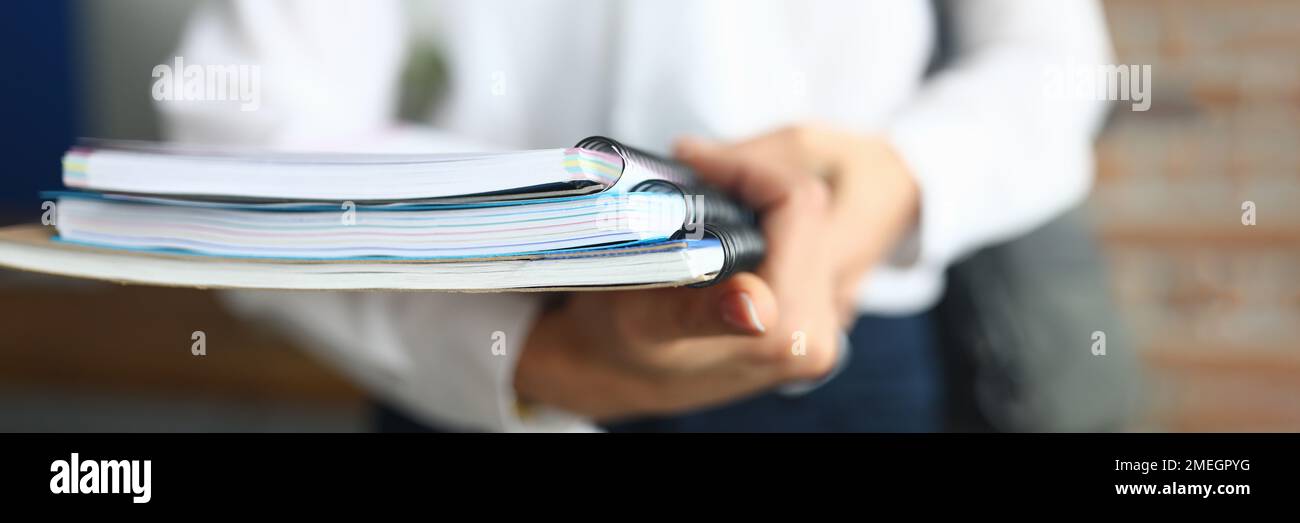 Female student holds folder and notebook in hands for studying Stock ...