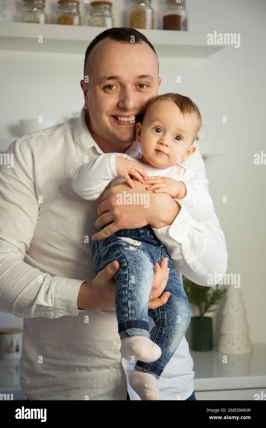 Portrait of a young loving father with a small child in his arms Stock ...