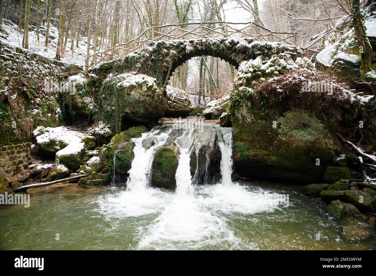 Scheissendempel waterfall, river Black Ernz with stone bridge covered ...