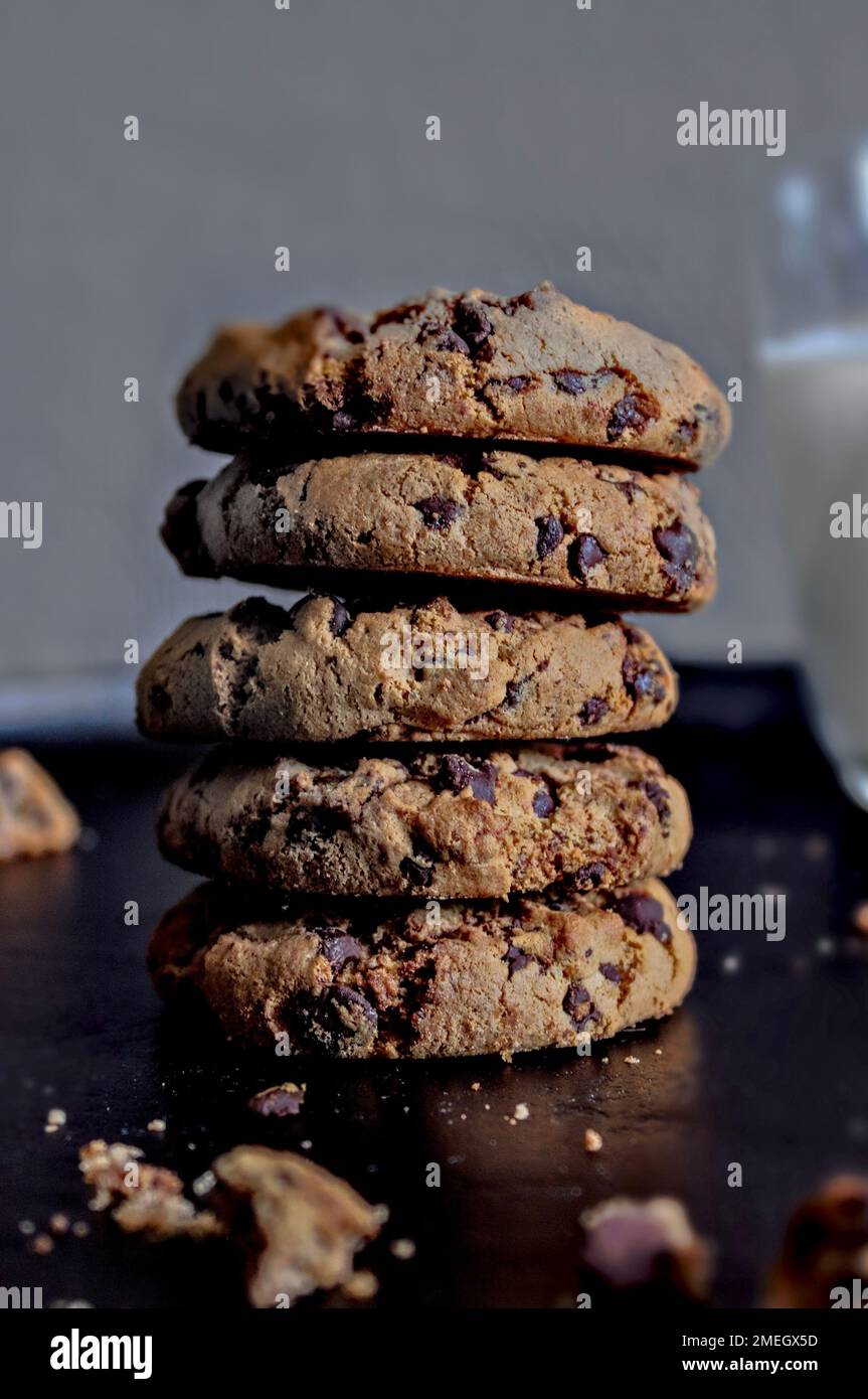 A vertical closeup of chocolate chip cookies stacked on top of each ...