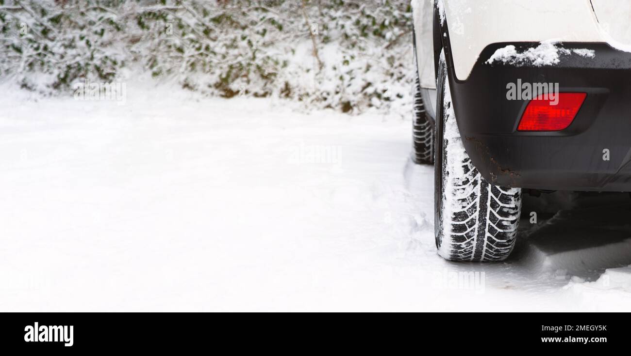 Car with winter tires on a snow covered road, winter weather, slippery ...
