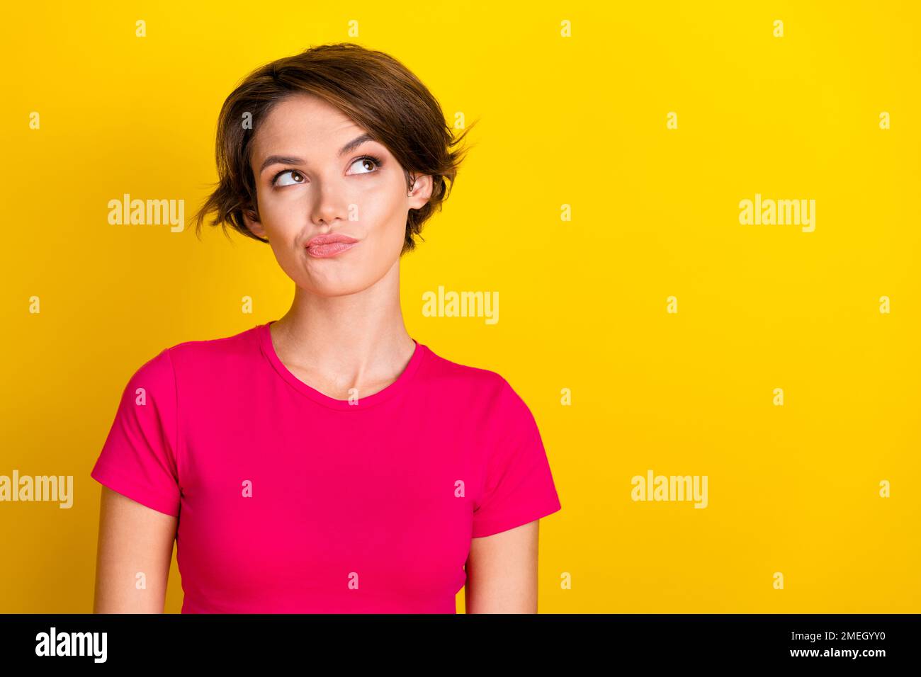 Photo of adorable doubtful lady wear pink t-shirt looking empty space ...