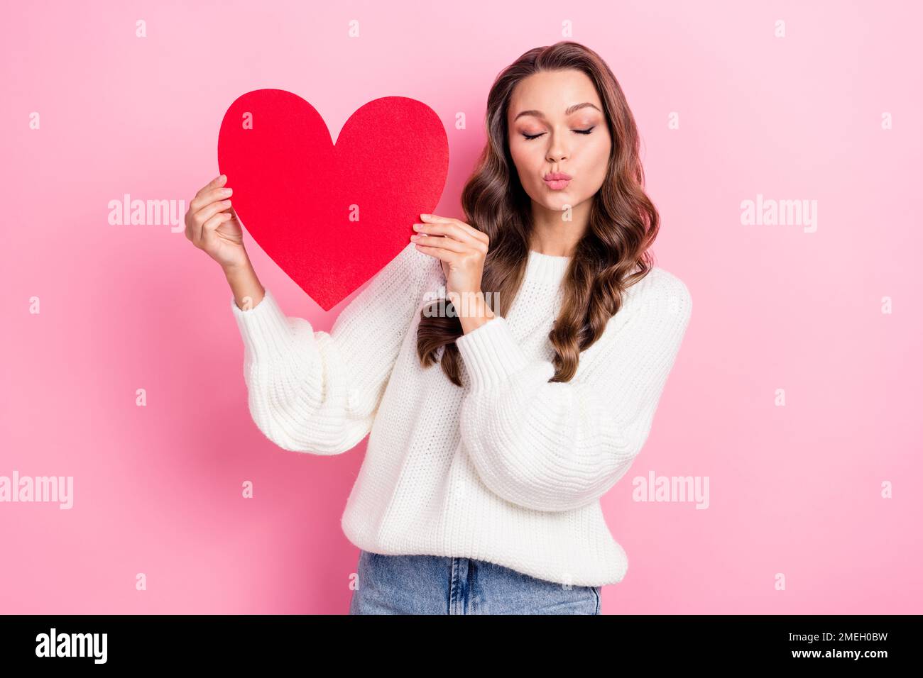 Photo of lovely cute girl closed eyes pouted lips kiss hold red paper ...