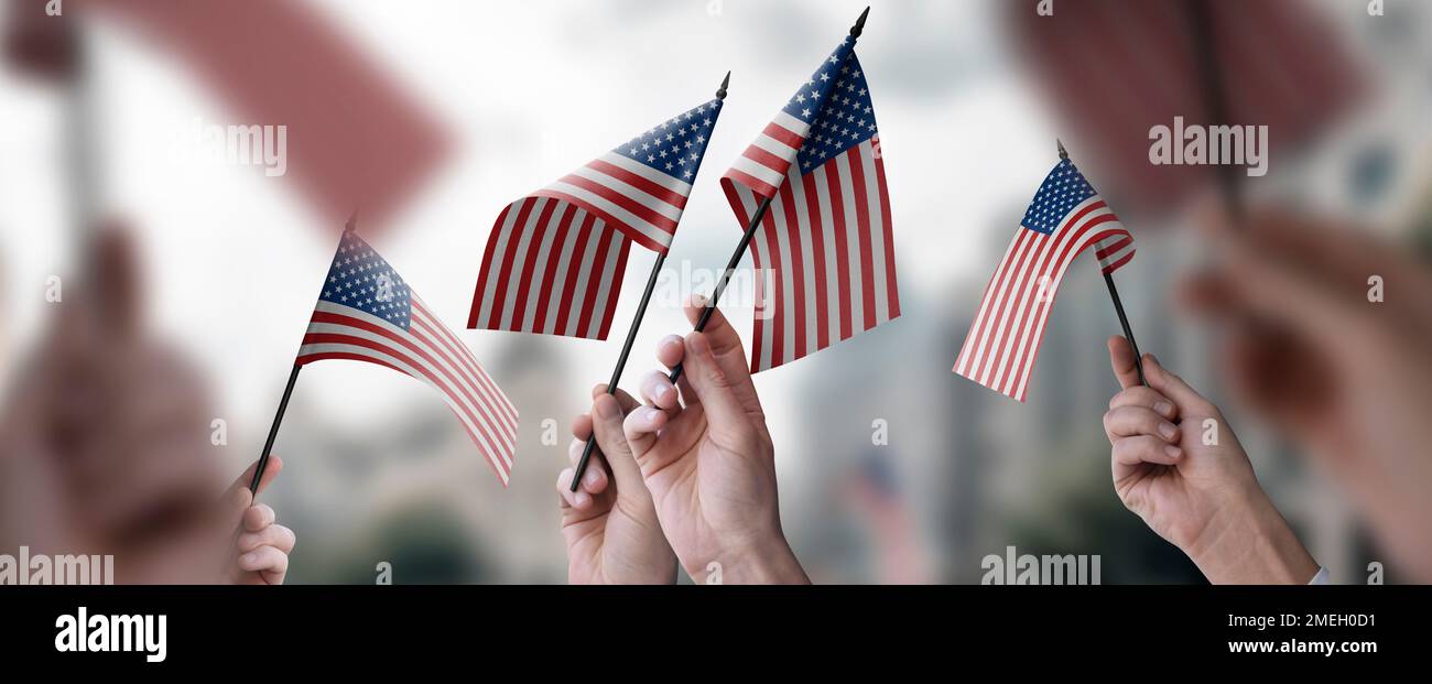 A group of people holding small flags of the USA in their hands Stock ...