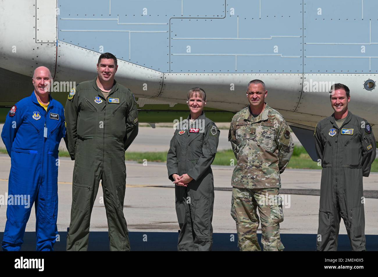 Service members stand next to an EC-37B Compass Call after its arrival ...