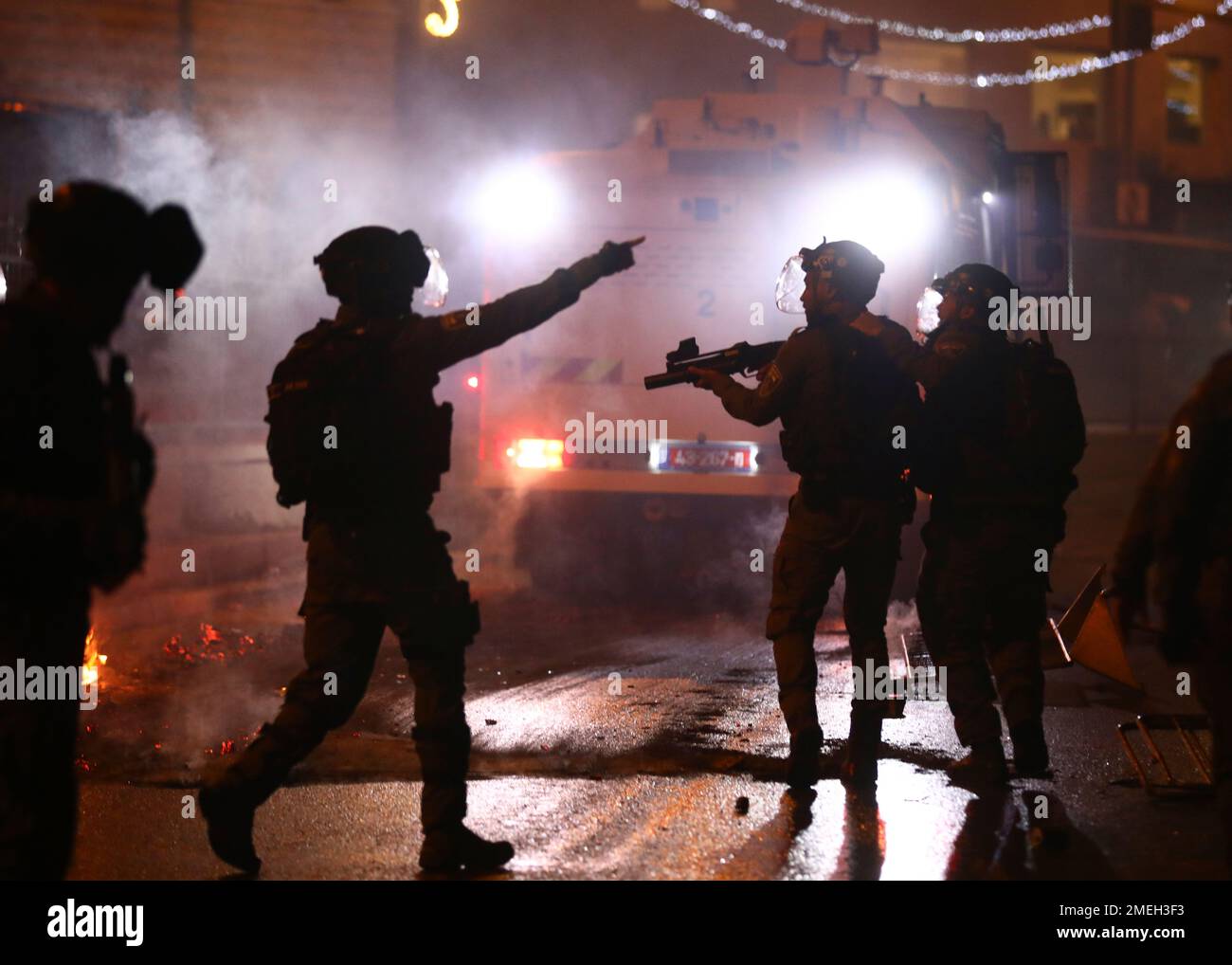 Israeli police officers fire stun grenades towards Palestinian ...