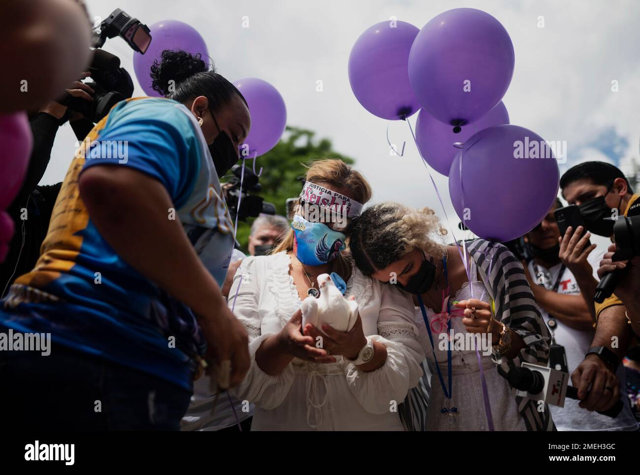 Bereliz Rodriguez leans on the shoulder of her mother Keila Ortiz who ...