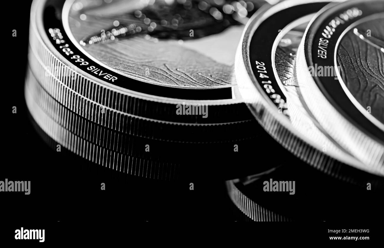 Macro Close up of Silver Bullion Coin on a black mirror background ...