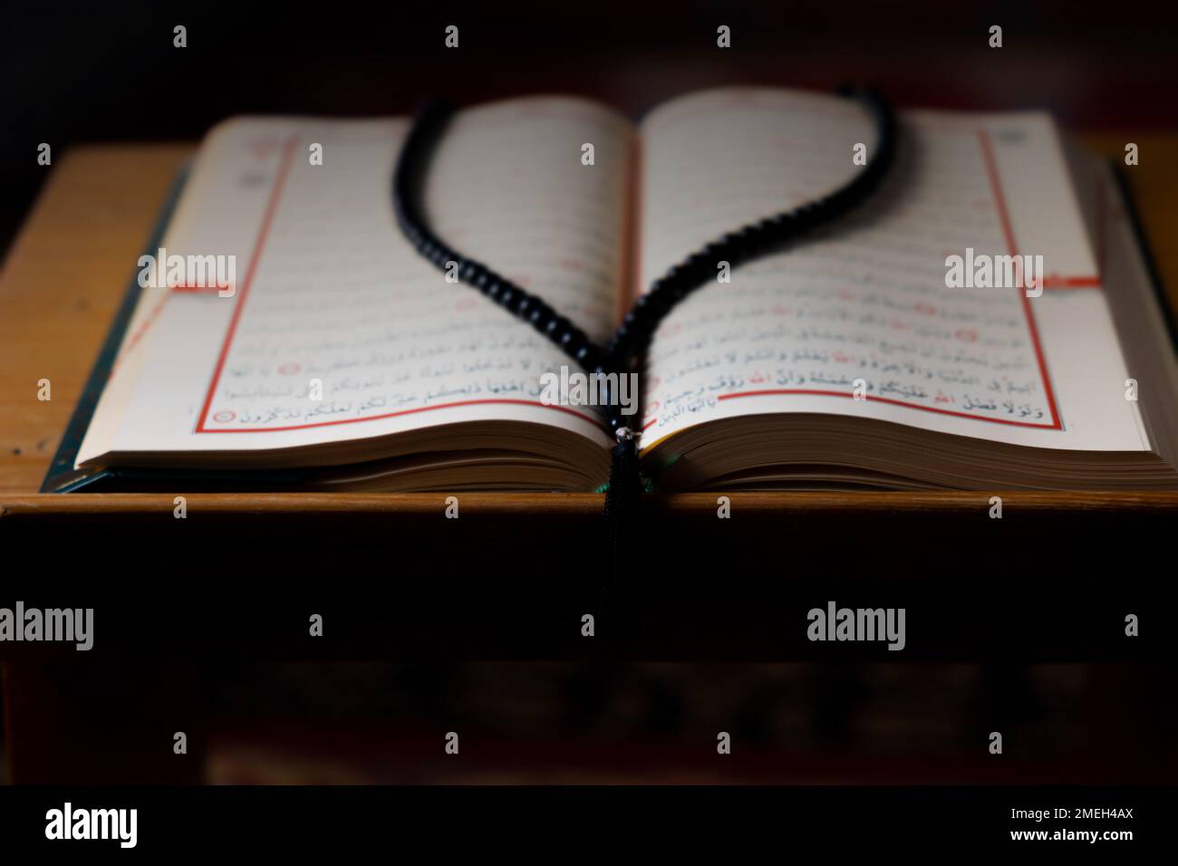 The Holy Quran on the lectern and praying beads. Islamic photo ...
