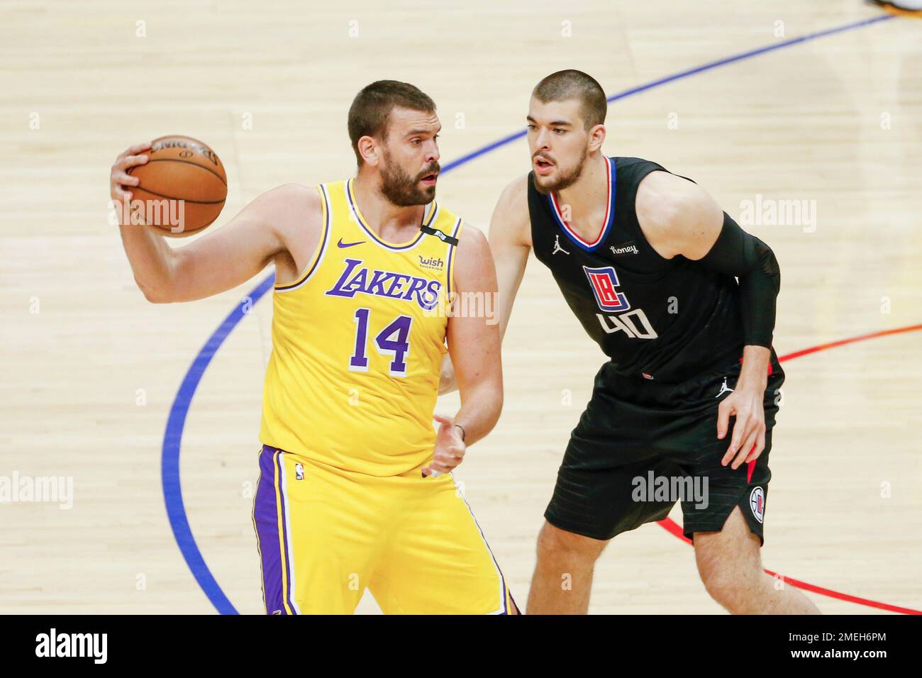 Los Angeles Lakers' Marc Gasol (14) is defended by Los Angeles Clippers ...