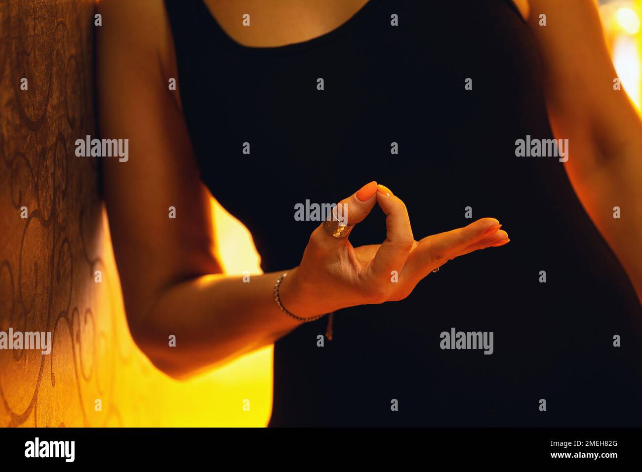 A woman practicing yoga, showing with her hands the symbol of jnana ...