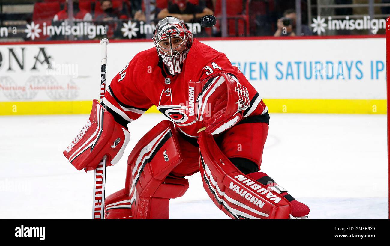 Carolina Hurricanes goaltender Petr Mrazek (34) tries to snare the puck ...