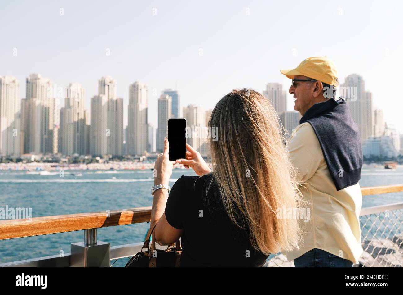 Tourist taking pictures of Dubai skyline Stock Photo - Alamy