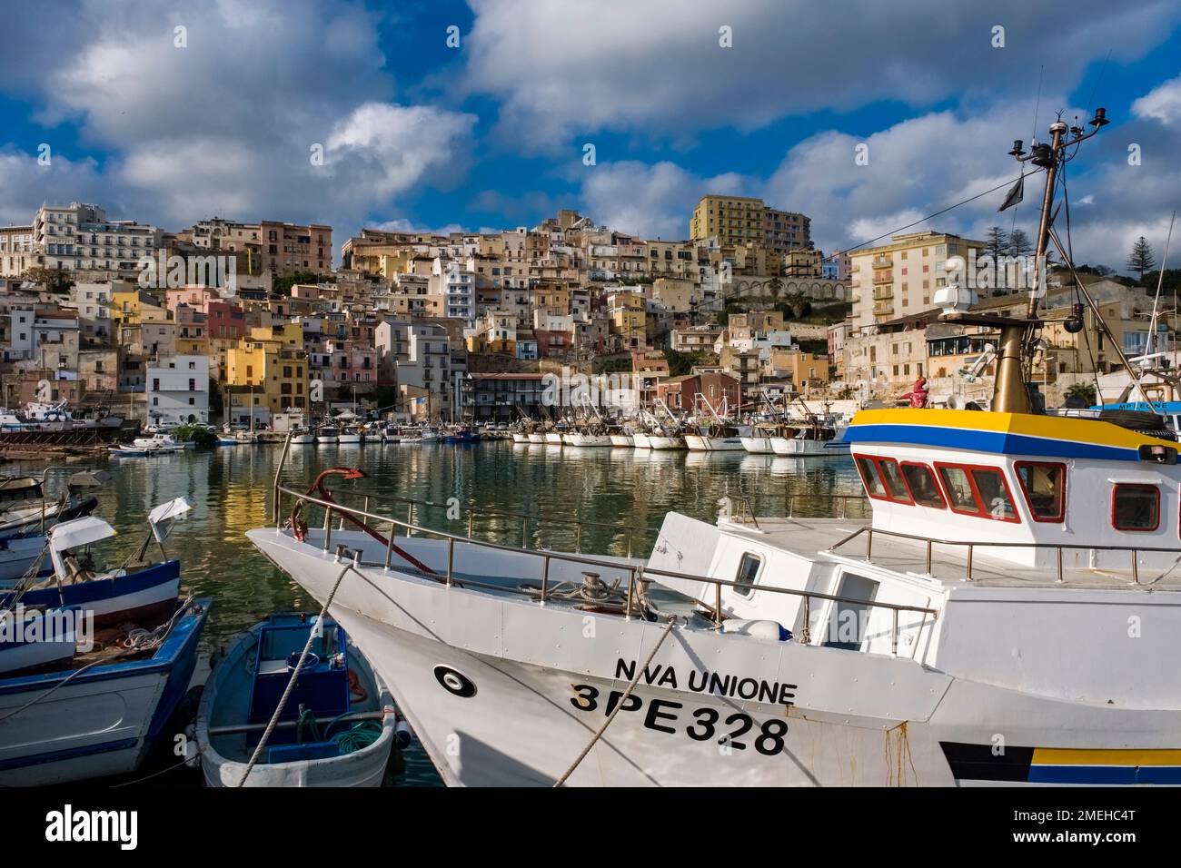 Colorful fishing boats are anchored in the harbour of Sciacca, the ...