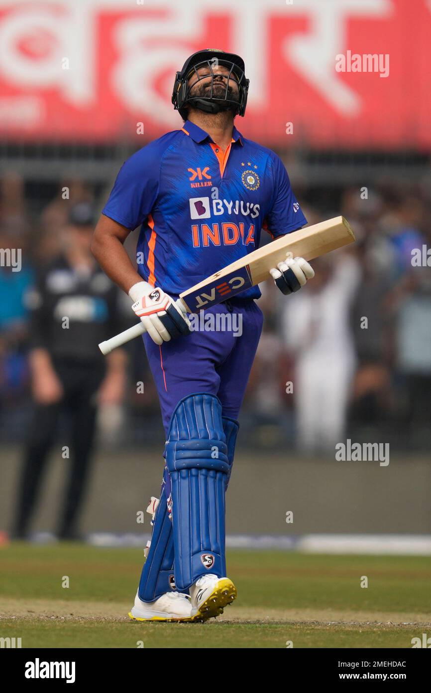 India's captain Rohit Sharma looks skywards to celebrate scoring a ...