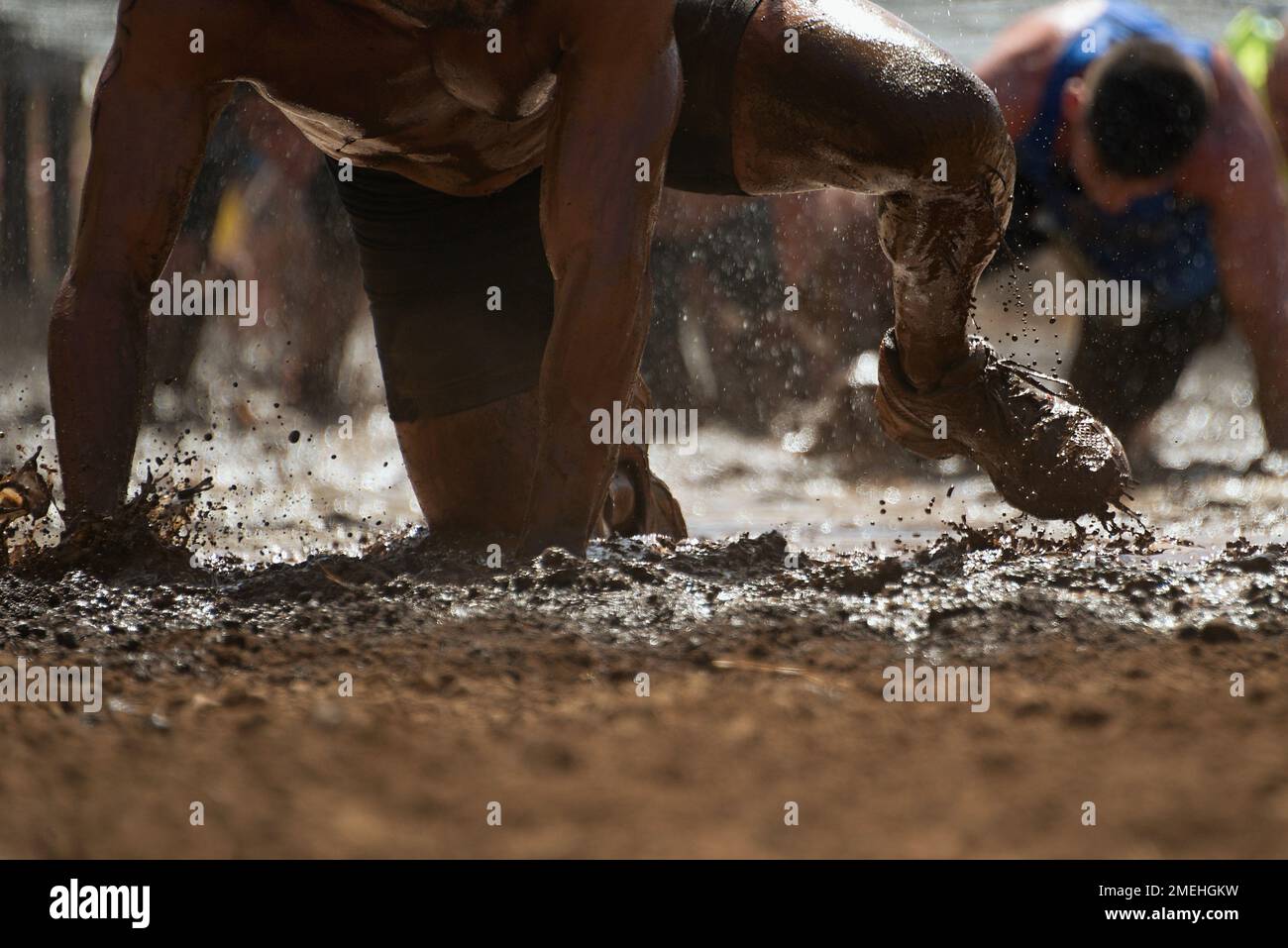 Mud race runners Stock Photo - Alamy