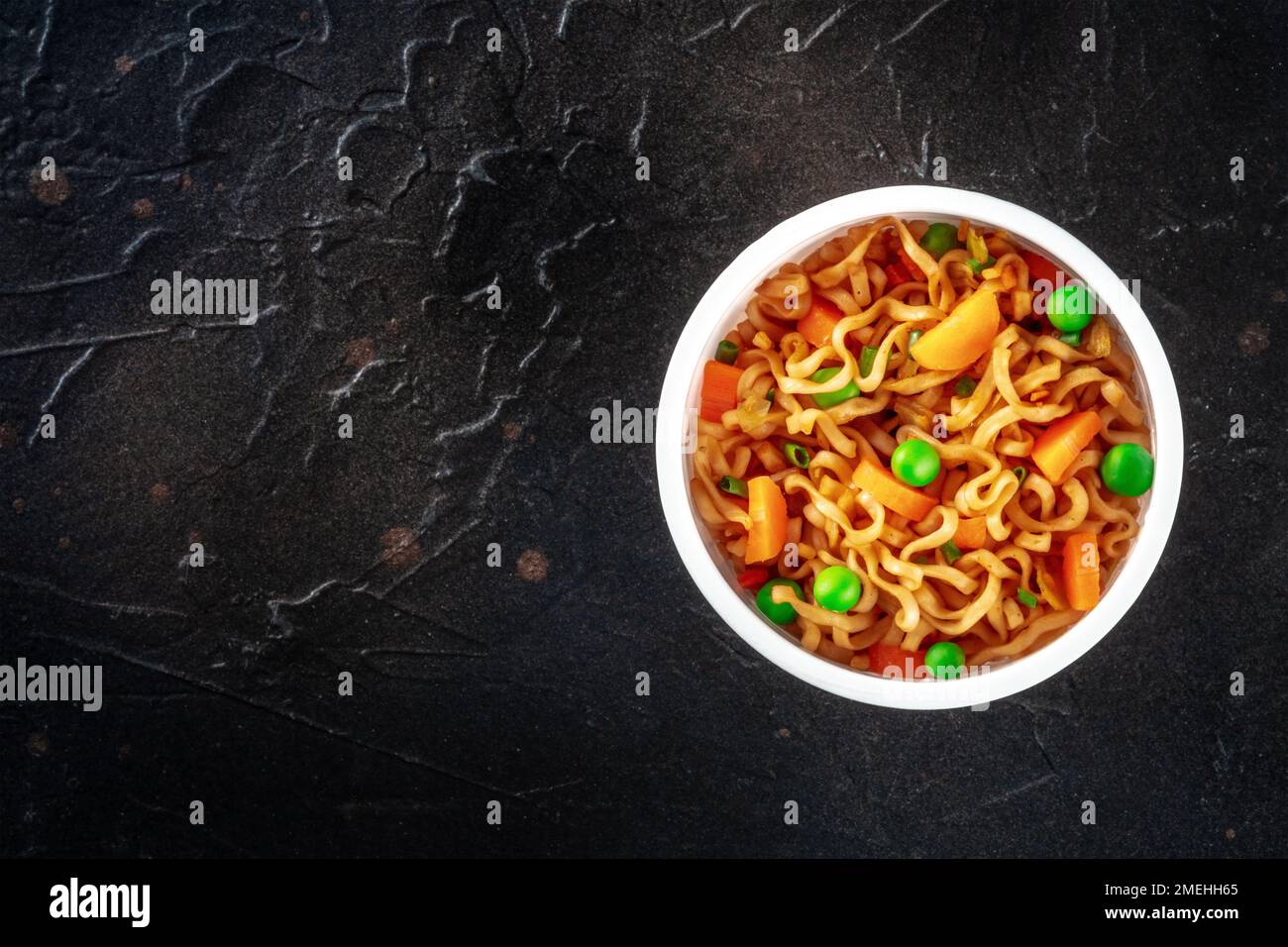 Ramen cup, instant soba noodles in a plastic cup with vegetables, shot ...