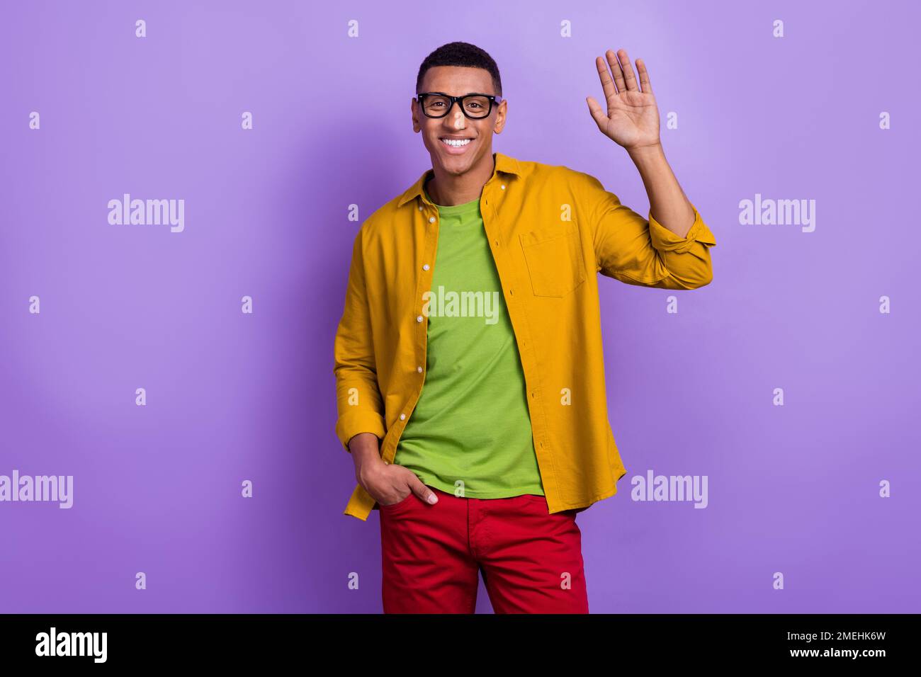 Photo portrait of nice young guy specs wave hand hello toothy smile ...