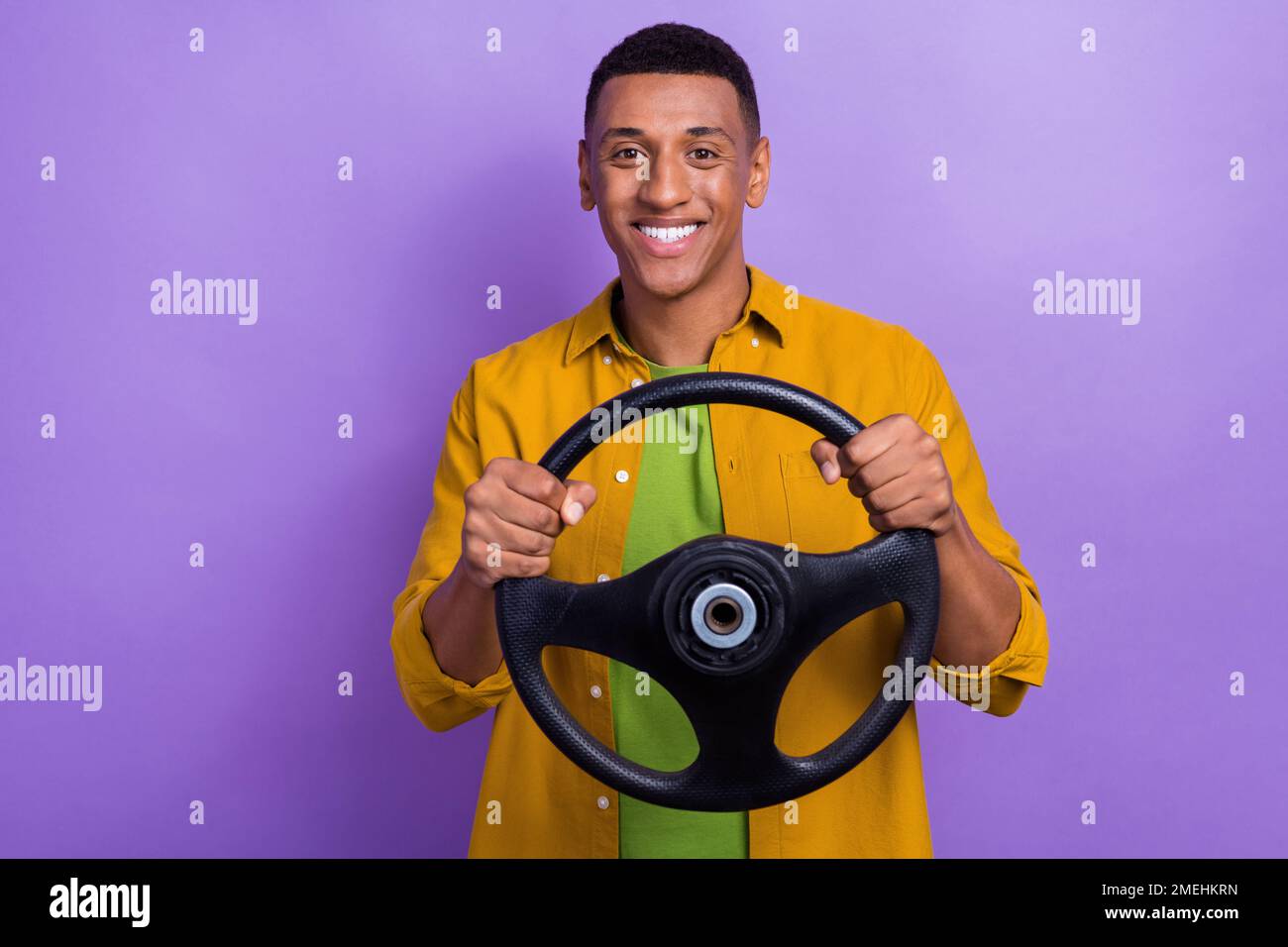 Photo portrait of nice young guy holding steering wheel driving lesson ...