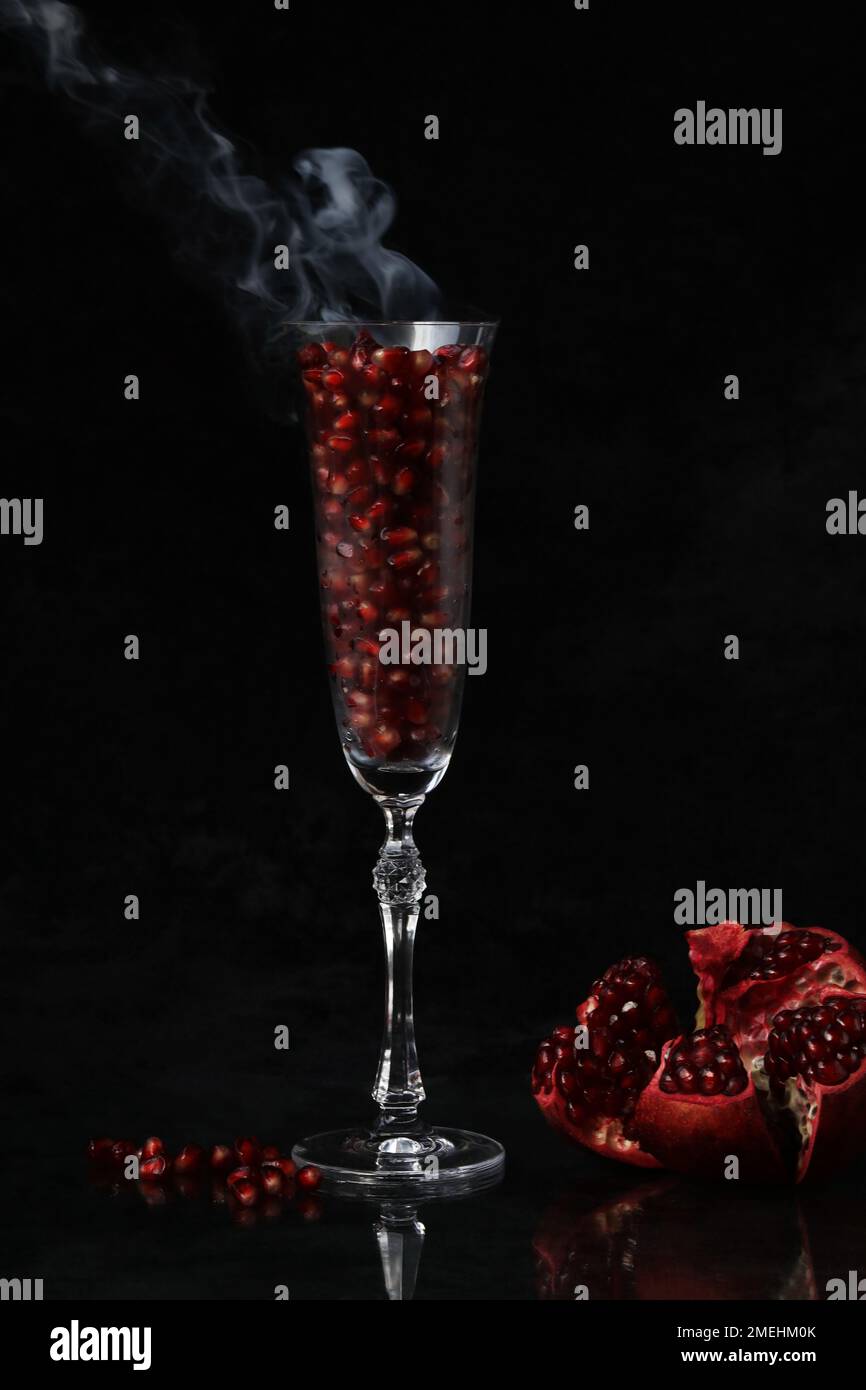 pomegranate wine in the glass on the black background Stock Photo - Alamy