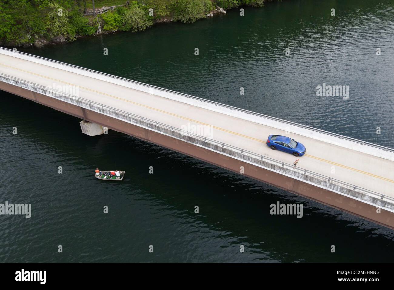 Anglers fish off a boat along a small bridge over the Loch Raven ...