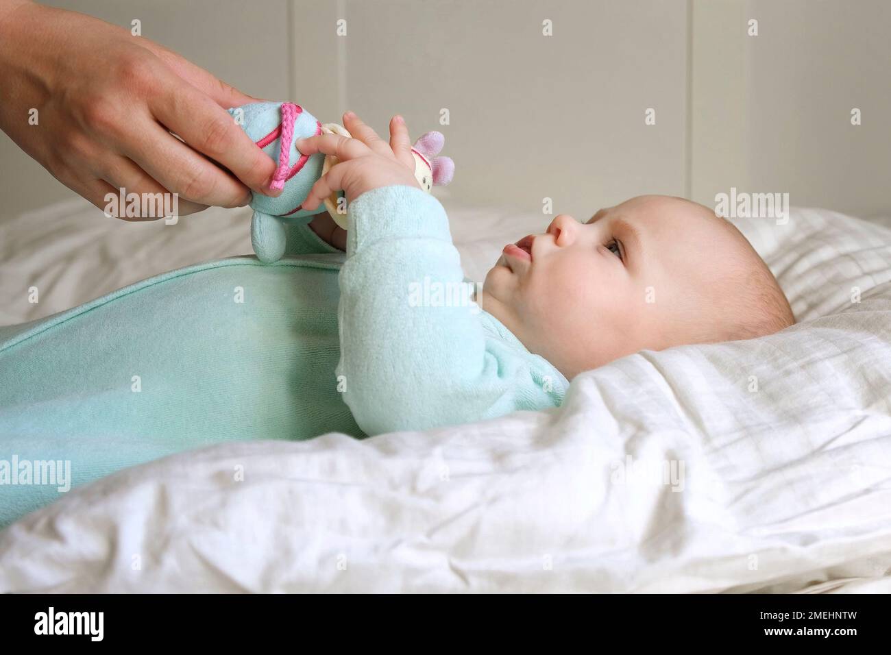 Cute Newborn Baby Lying on the Back and Plays with Colorful Toys ...