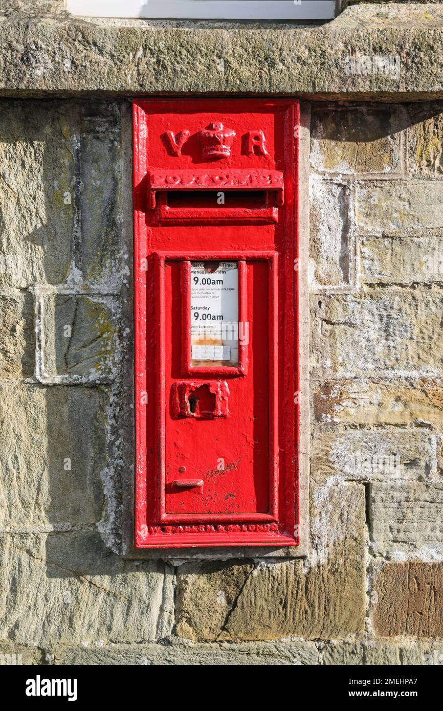 Bright red V R Post Box on a wall at Bere Alston Railway Station in ...