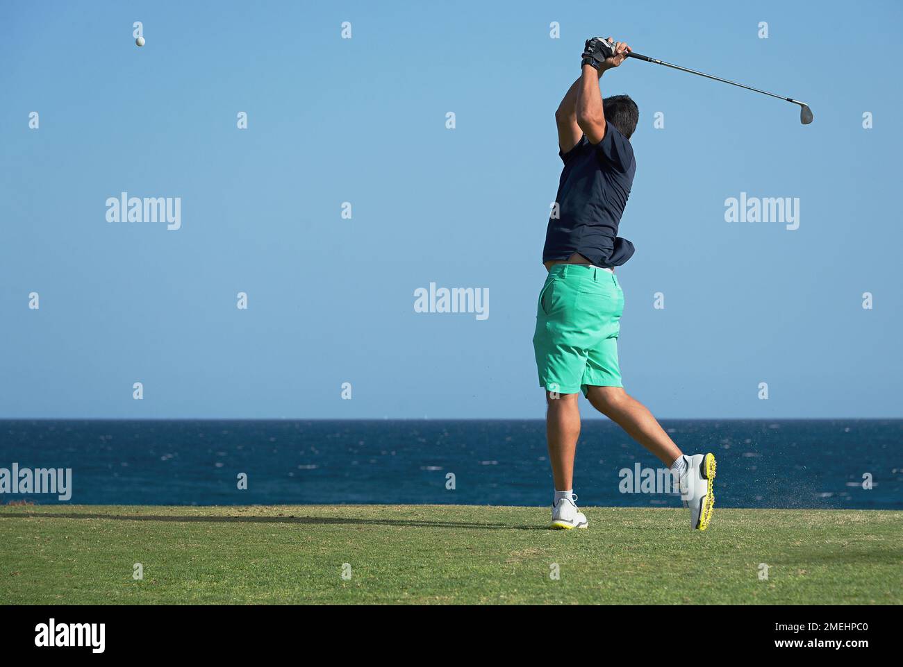 Golfer hitting ball with force. The grass distribution the blur of golf ...