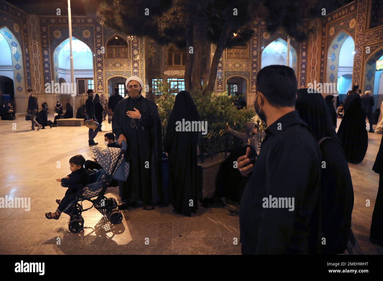A clergyman along with his family attends a ceremony at the Laylat al ...