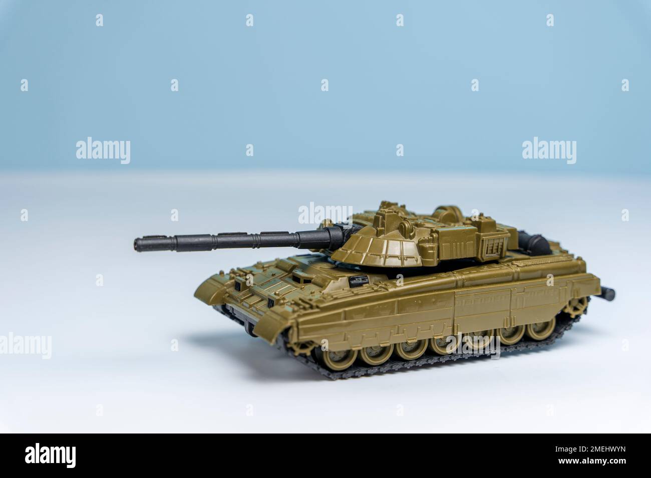 toy military tank rides on the surface on a light background Stock ...
