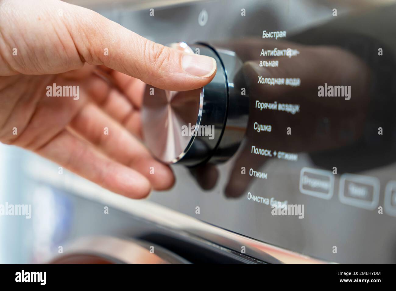 woman's hand selects the washing mode with a round selector Stock Photo ...