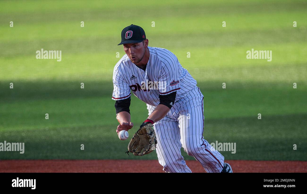 Omaha infielder Keil Krumwiede (11) scoops the ball against Western ...