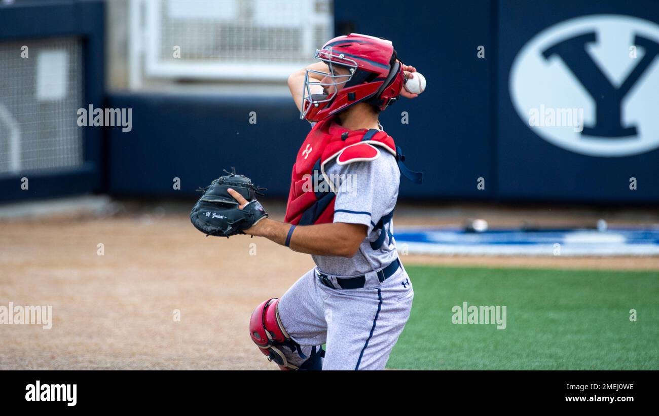 Saint Mary's (CA) catcher JC Santini (23) throws the ball back to the ...