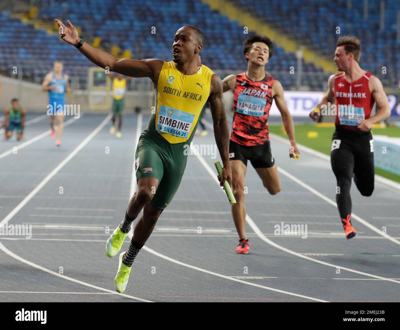 South Africa's Akani Simbine, left, reacts after winning the Men's ...