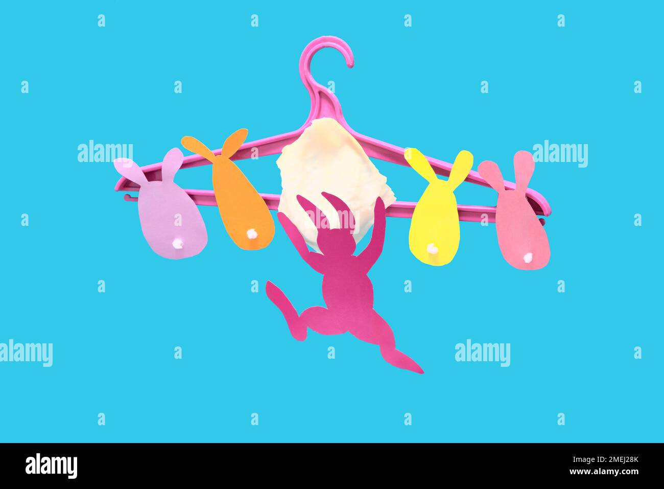 The rabbit is hanging from a cabbage on a clothes hanger. Easter ...