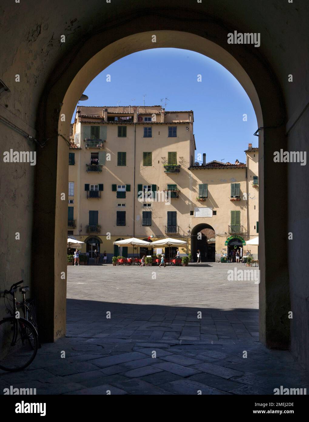 The famous round square Piazza dell Anfiteatro in the city of Lucca ...