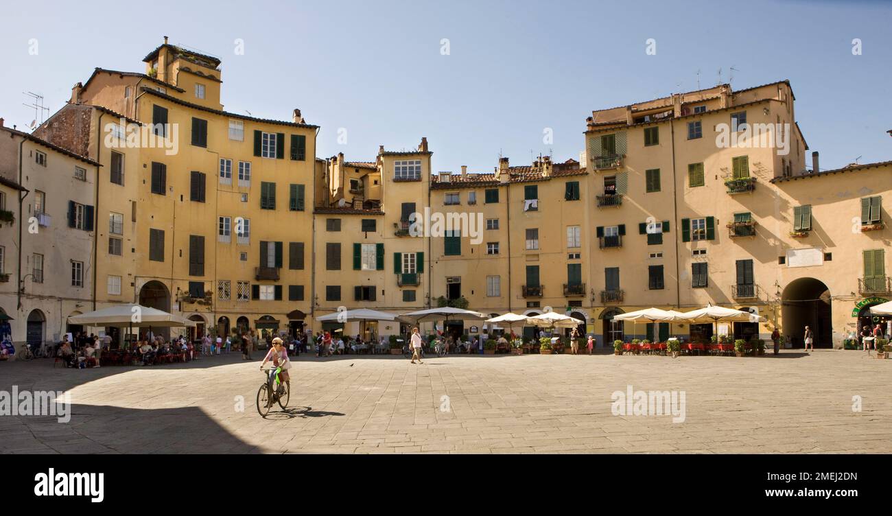 The famous round square Piazza dell Anfiteatro in the city of Lucca ...
