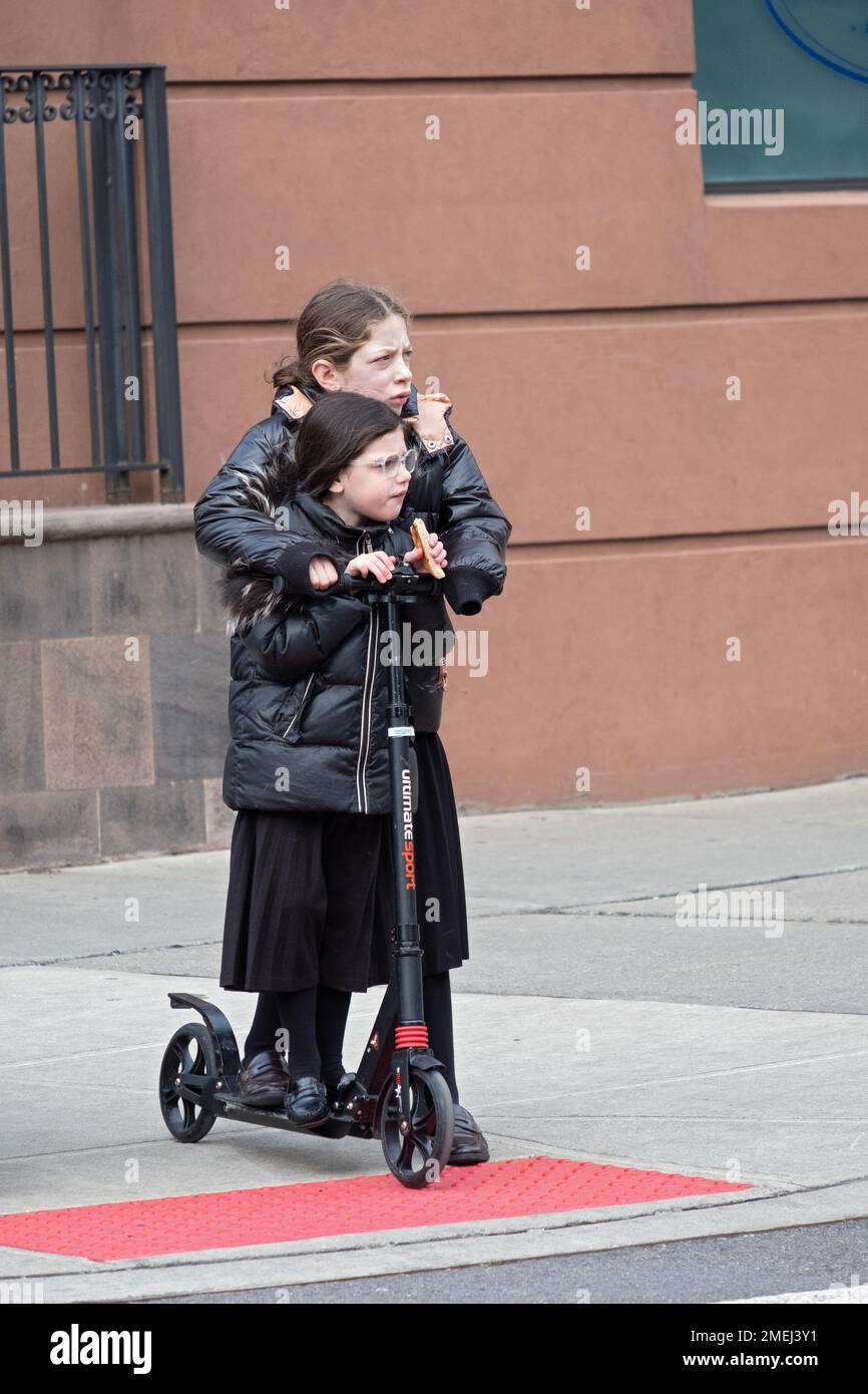 Orthodox Jewish Girls Likely Sisters Stop Their Scooter At A Corner Waiting For The Light To