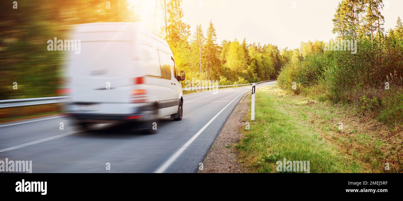 Van moving on the country road in natural park on the sunset Stock ...