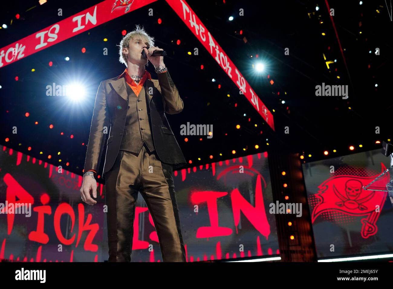 Machine Gun Kelly speaks to the crowd during the second day of the NFL ...