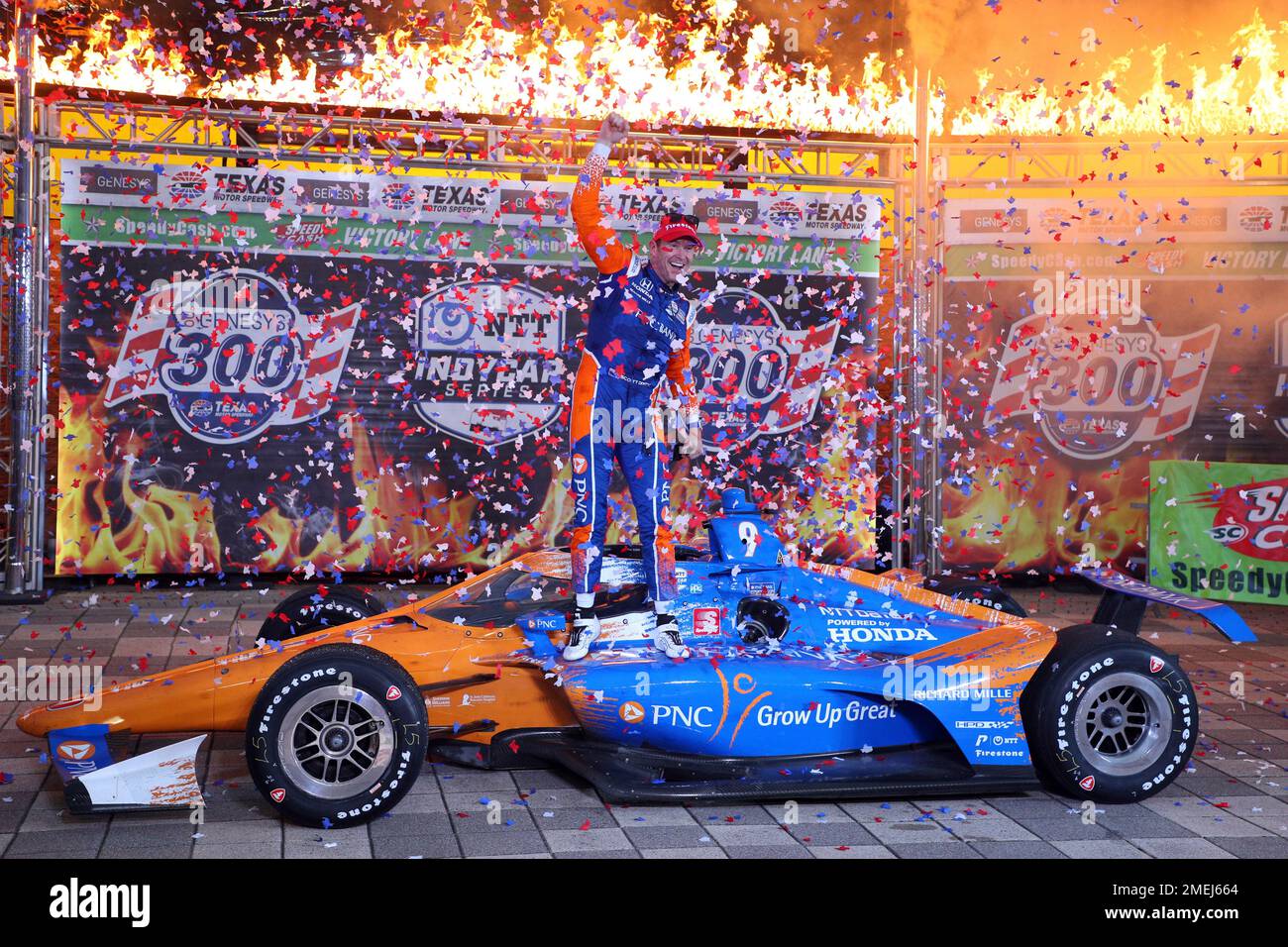 Scott Dixon stands on his car as he celebrates winning an IndyCar ...